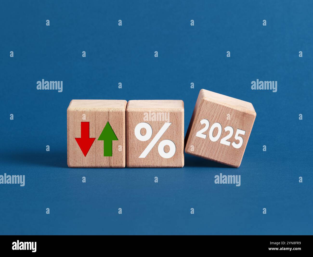Wooden cubes showing percentage symbol and fluctuating arrows suggesting interest rate changes ...