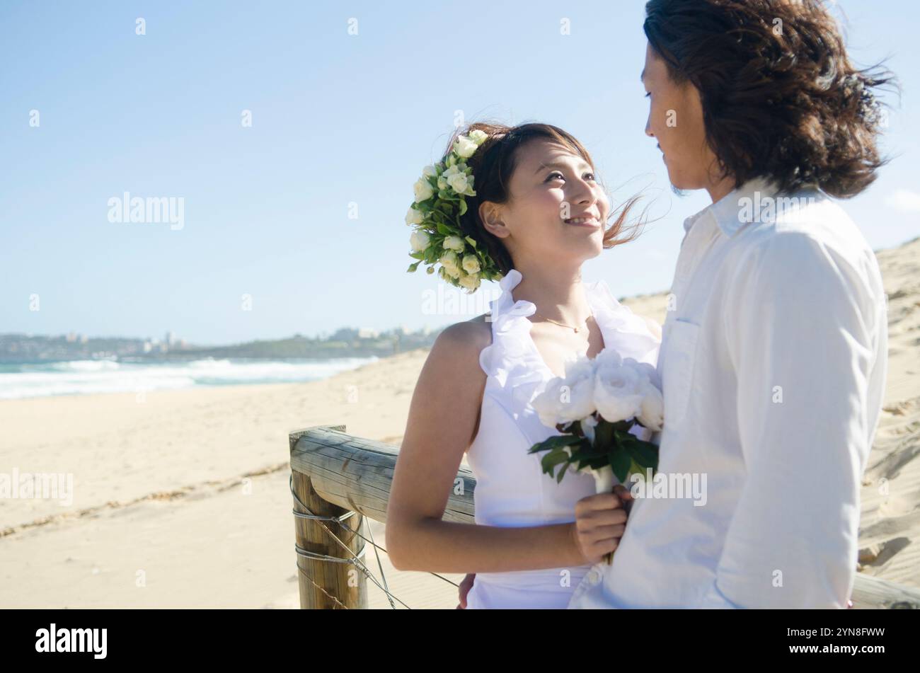 Couple cuddling on the beach Stock Photo - Alamy
