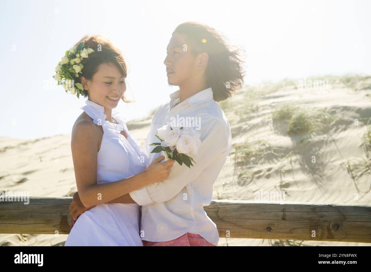 Couple cuddling on the beach Stock Photo - Alamy