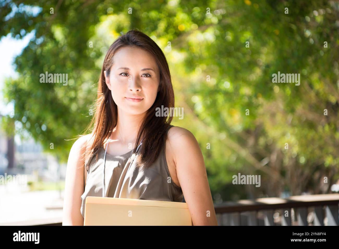Working women looking at us outside Stock Photo - Alamy