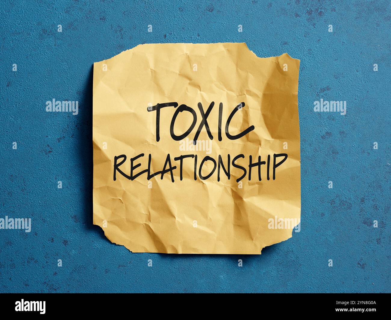 Crumpled paper with toxic relationship on blue background symbolizes ...