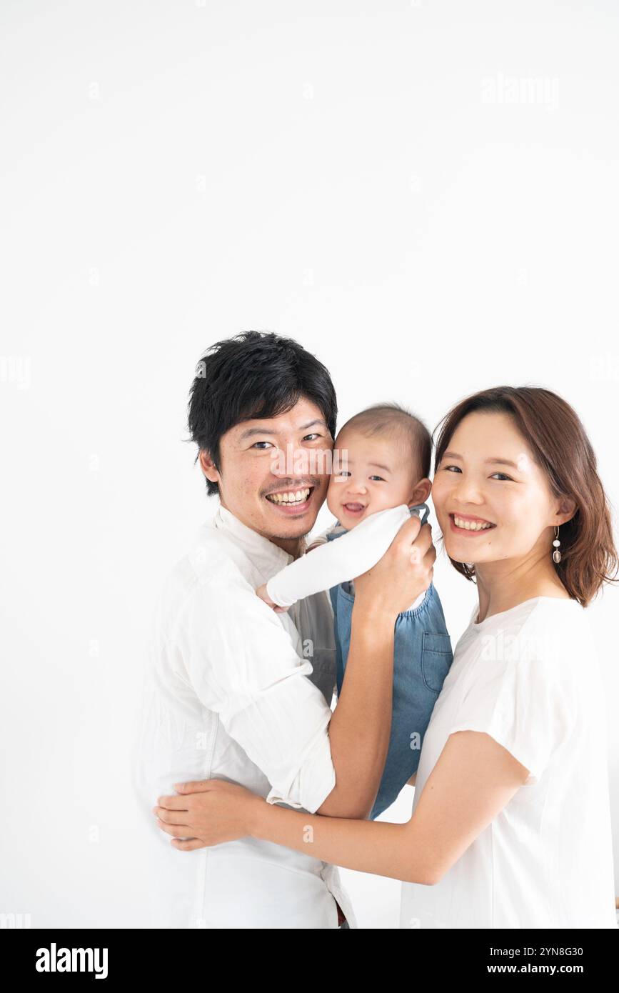 Family laughing while carrying baby Stock Photo - Alamy
