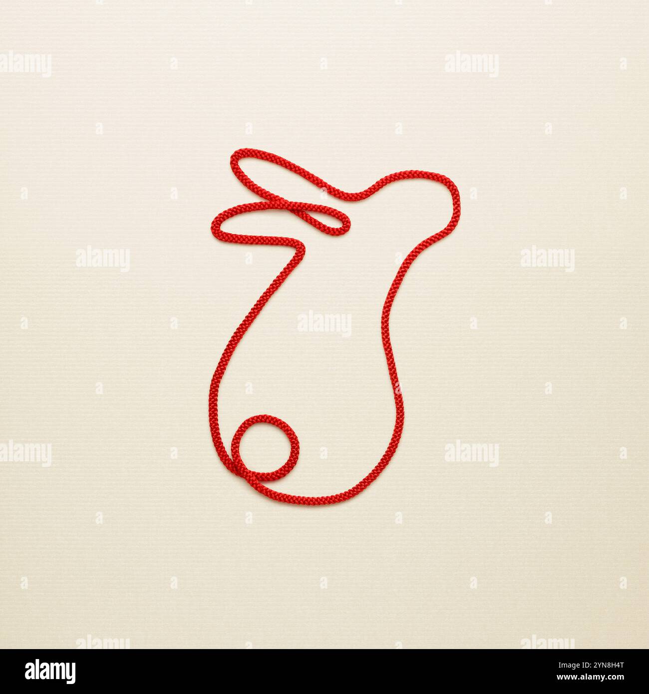 Image of a rabbit made with red string Stock Photo - Alamy