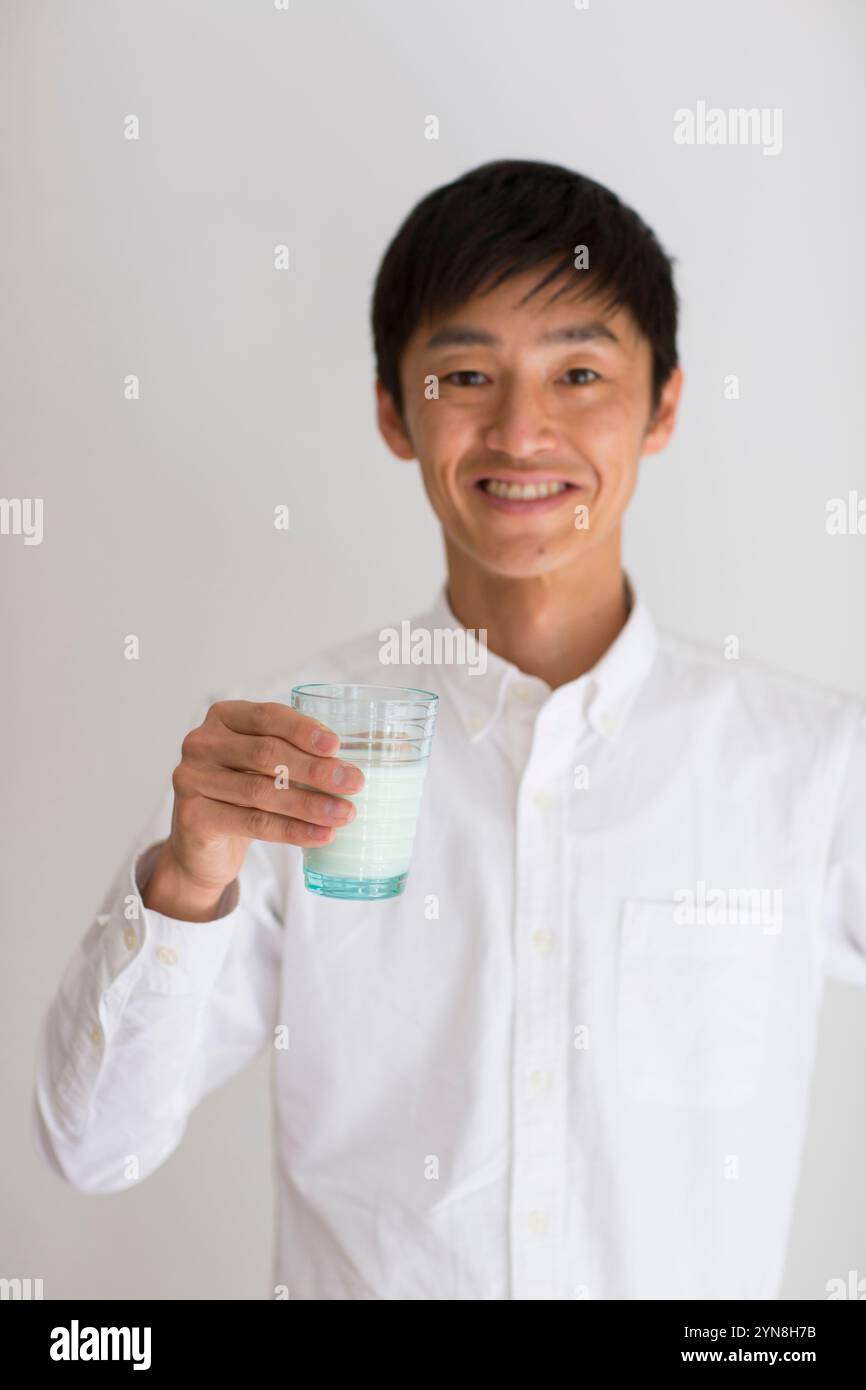Man holding glass milk hi-res stock photography and images - Alamy
