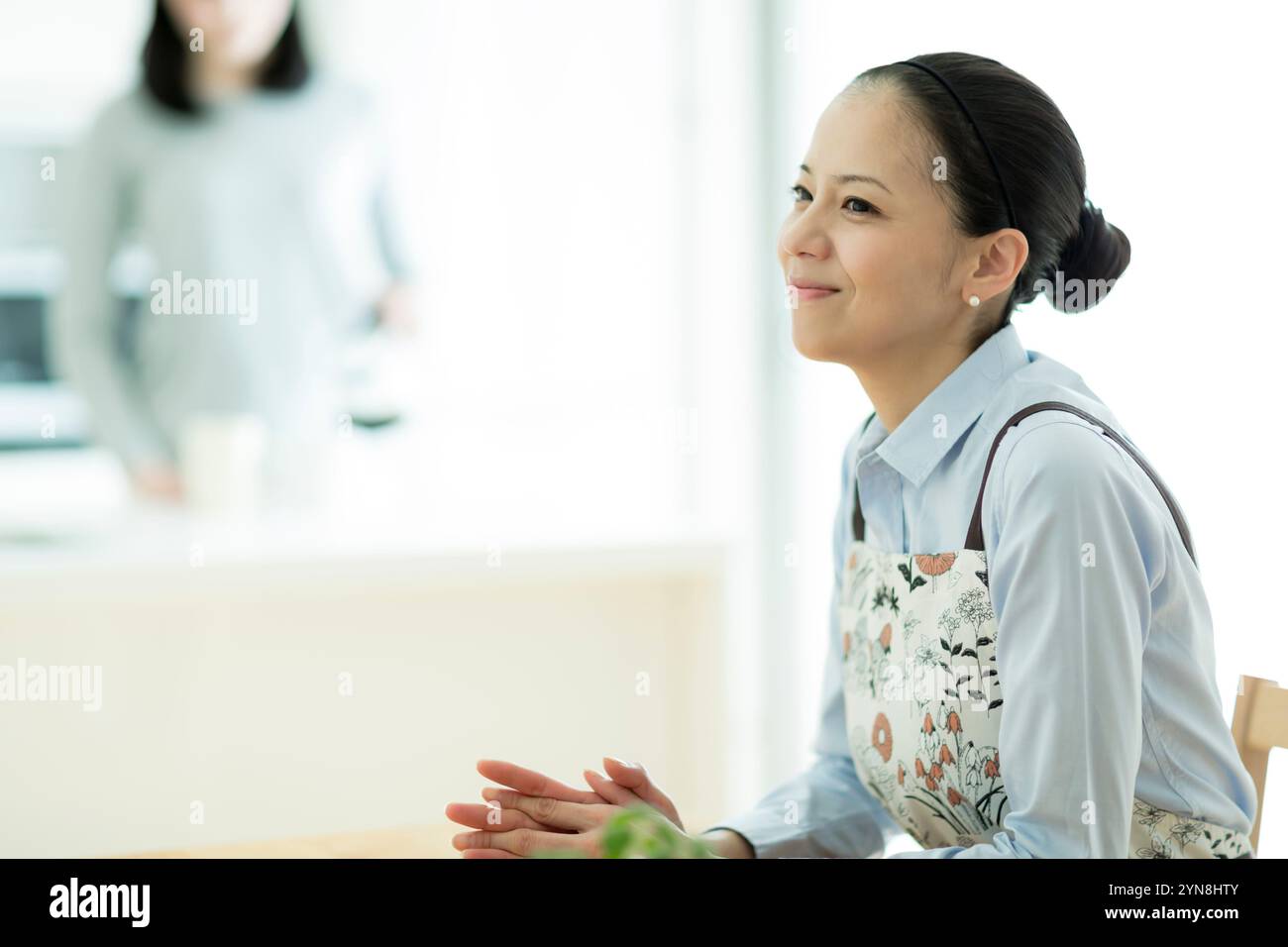 Mother thinking at table Stock Photo - Alamy