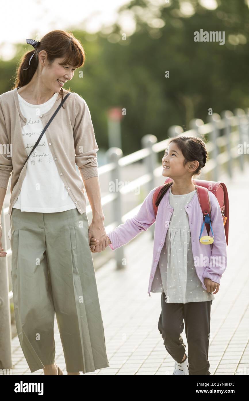 Parent and child walking hand in hand Stock Photo - Alamy