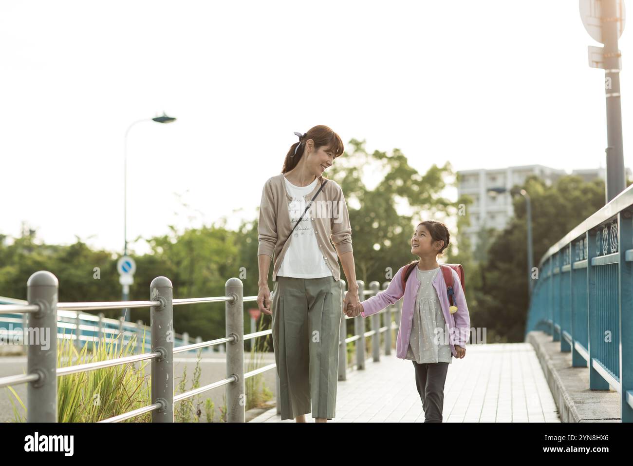 Parent and child walking hand in hand Stock Photo - Alamy