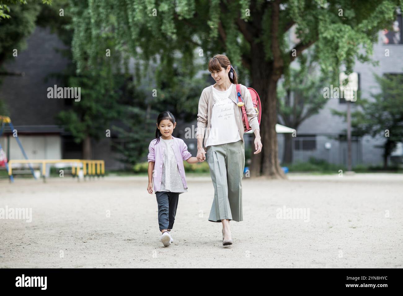 Parent and child walking in park Stock Photo - Alamy