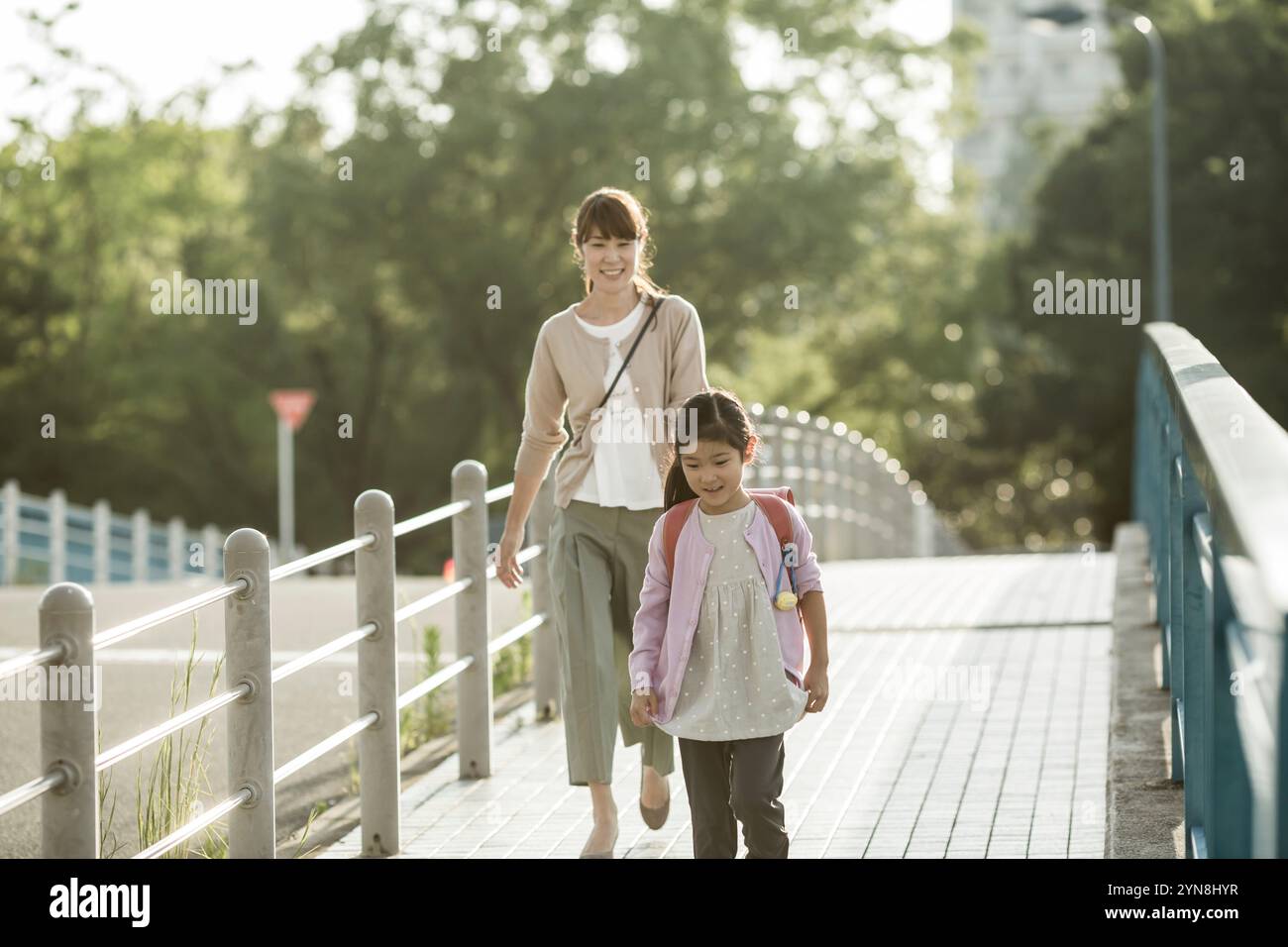 Parent and child walking on the bridge Stock Photo - Alamy