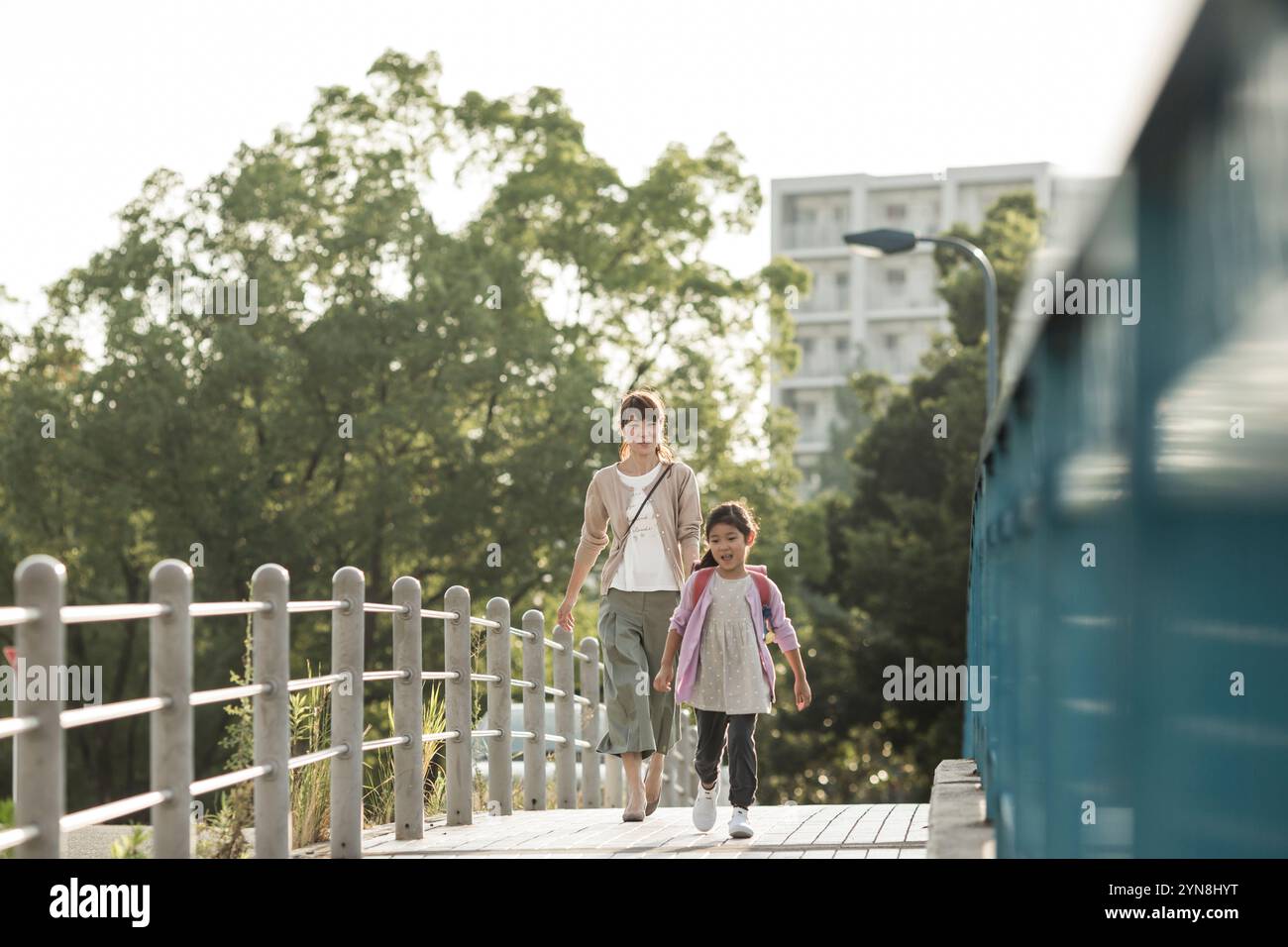 Parent and child walking on the bridge Stock Photo - Alamy