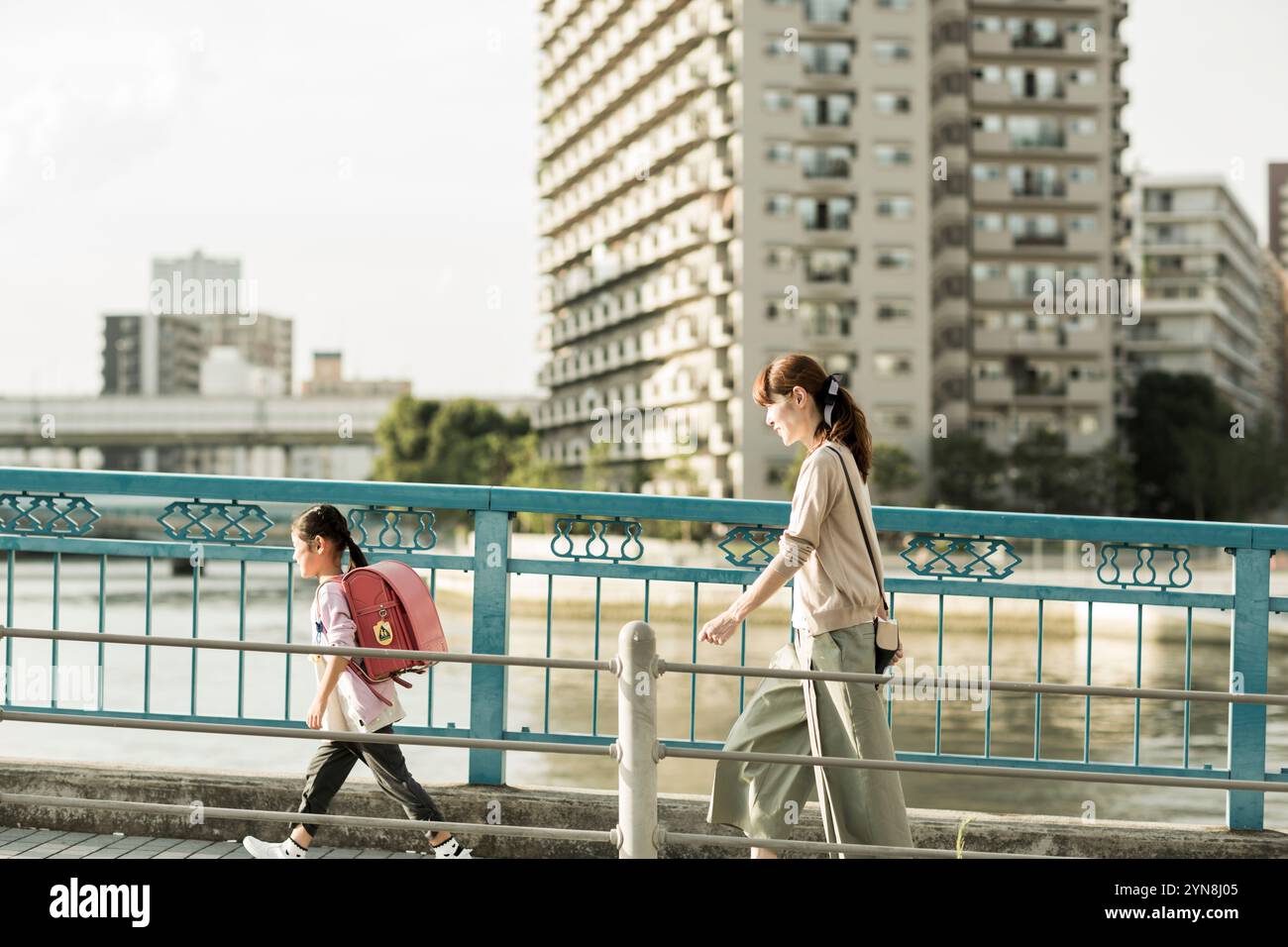 Parent and child walking on the bridge Stock Photo - Alamy