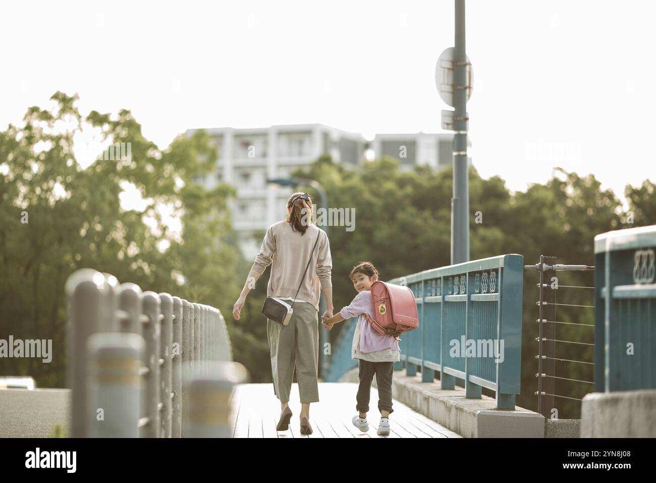 Parent and child walking hand in hand Stock Photo - Alamy