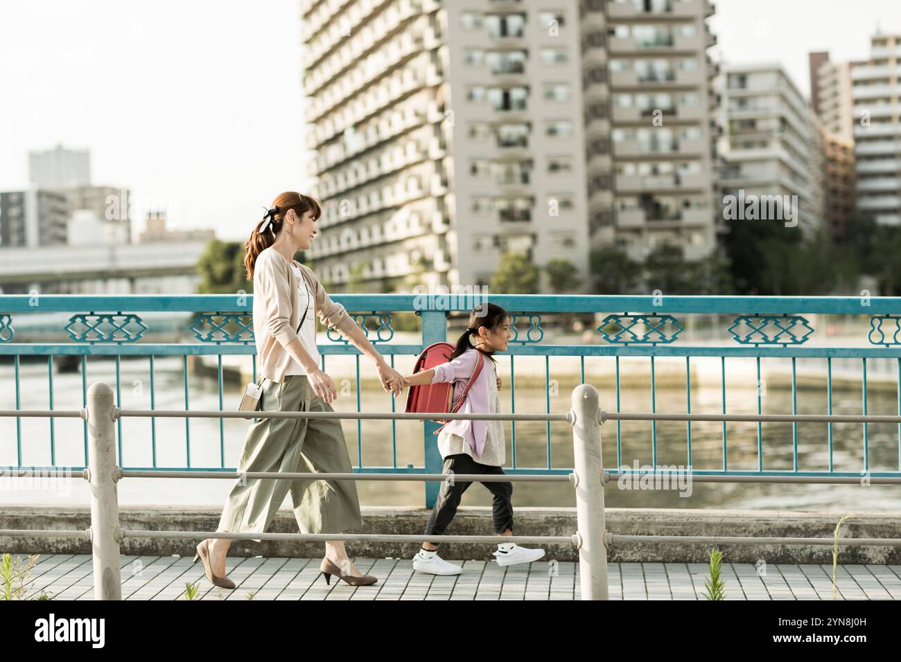Parent and child walking on the bridge Stock Photo - Alamy