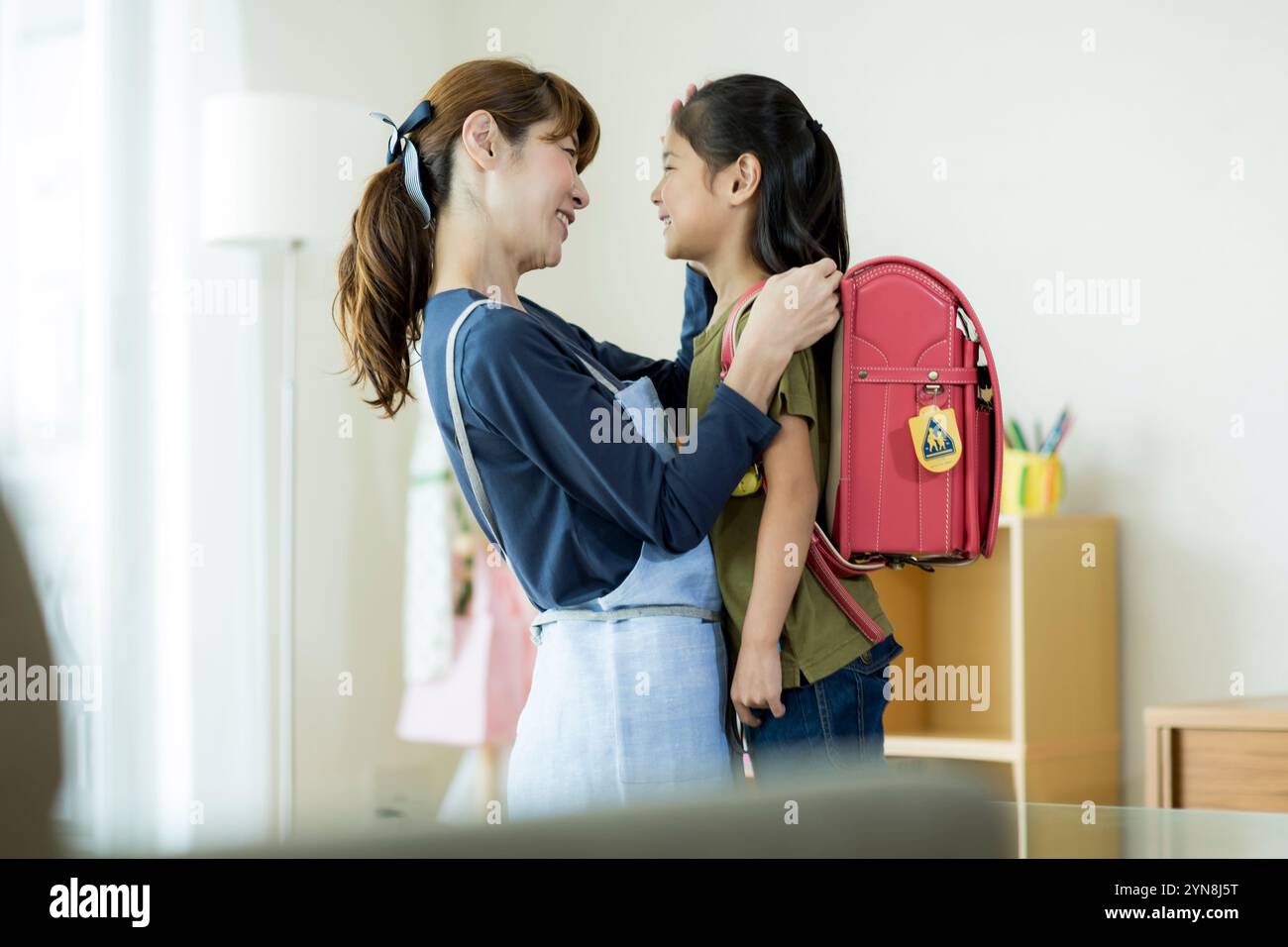 Parent and child facing each other smiling Stock Photo - Alamy