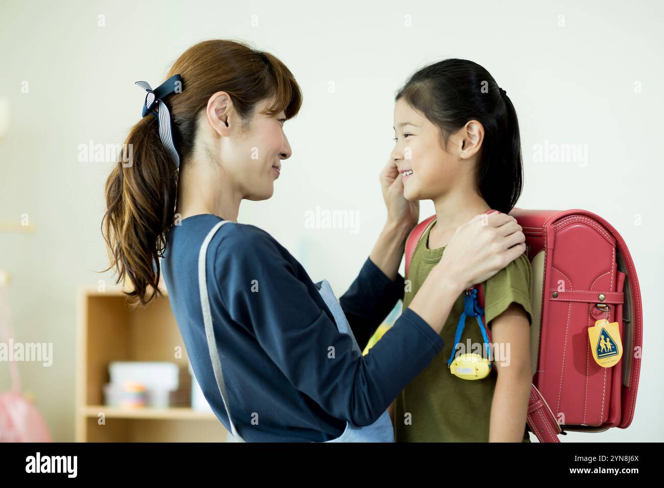 Parent and child facing each other smiling Stock Photo - Alamy