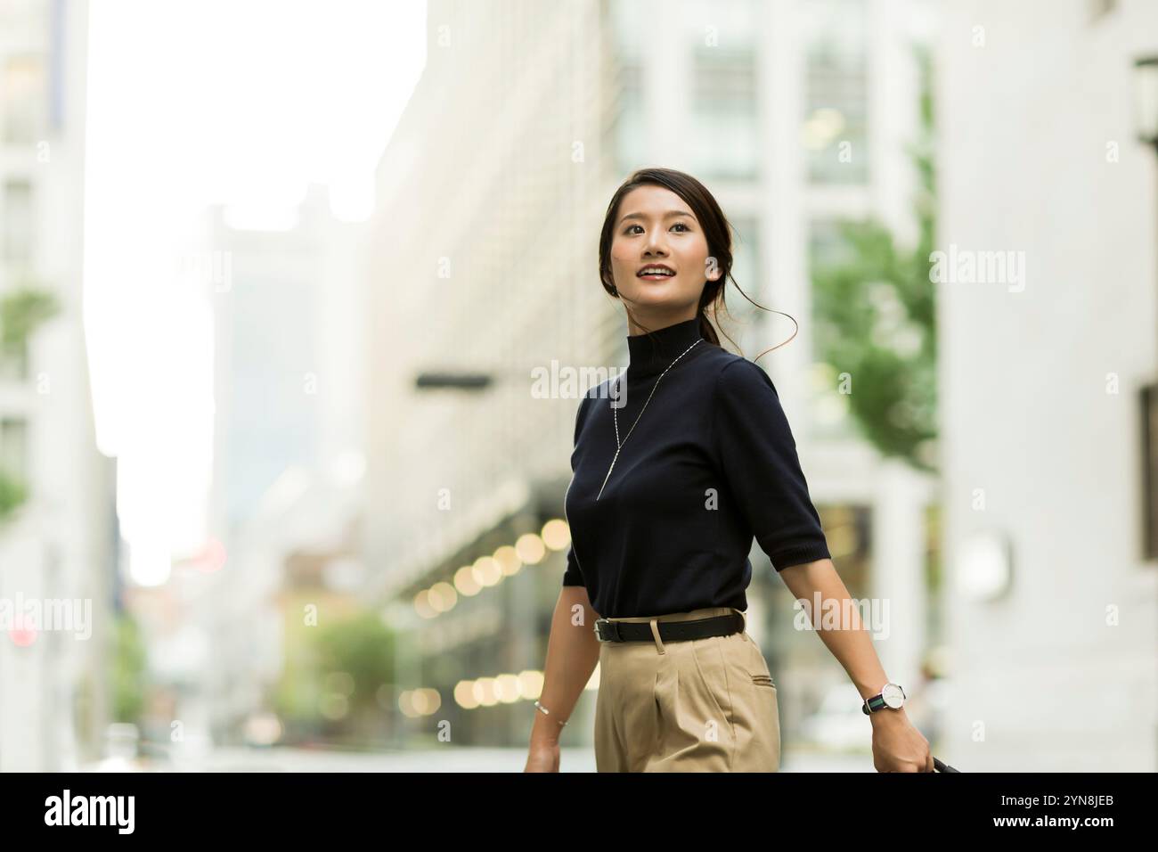 Businesswoman walking with a smile Stock Photo - Alamy