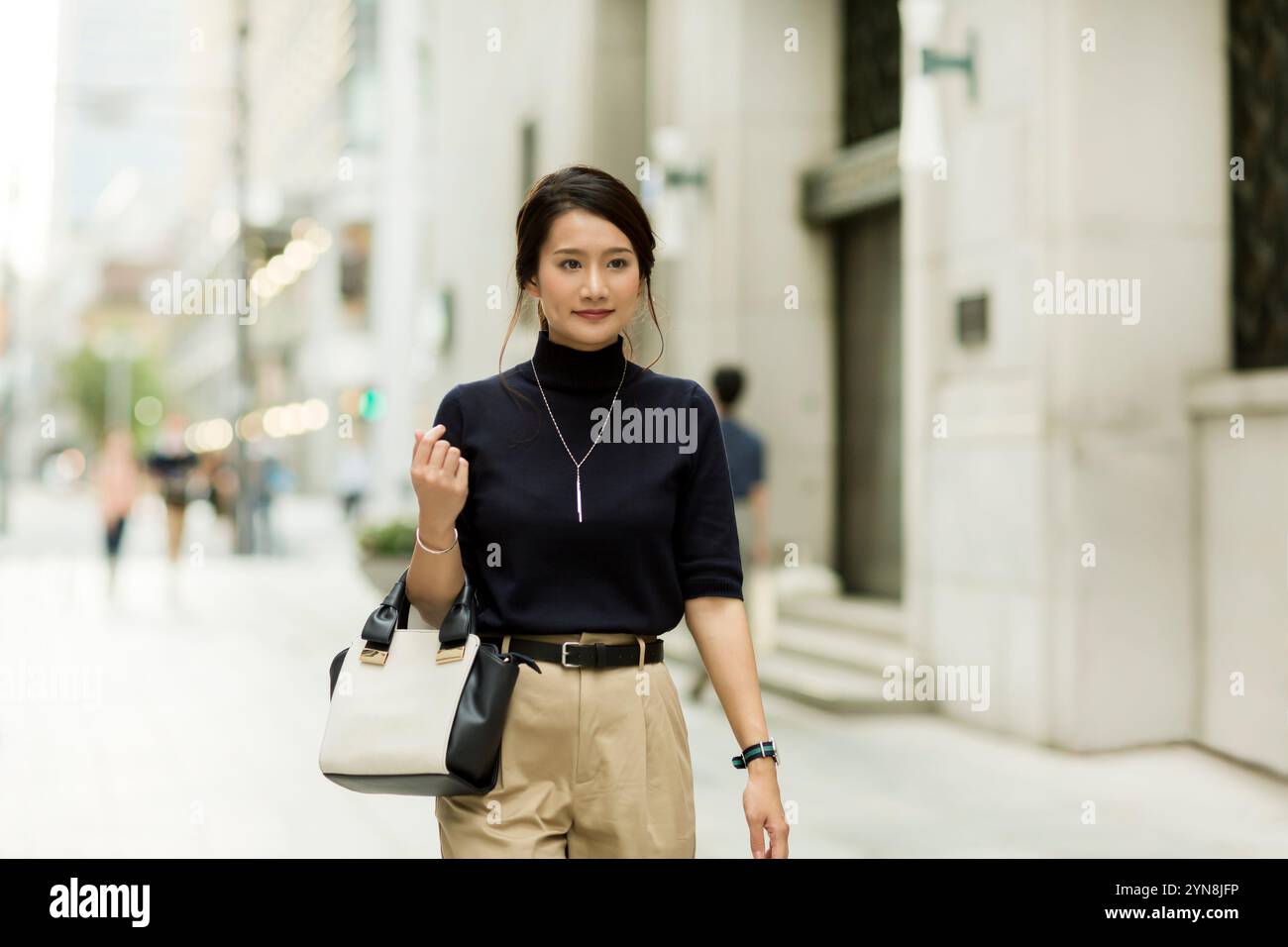 Businesswoman walking with a smile Stock Photo - Alamy