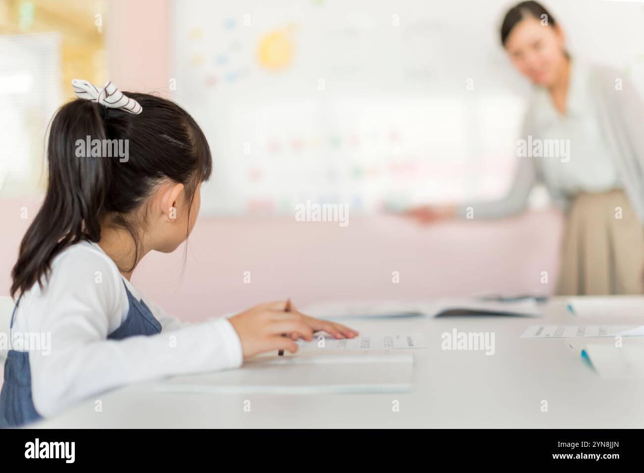 Girls studying in a classroom Stock Photo - Alamy
