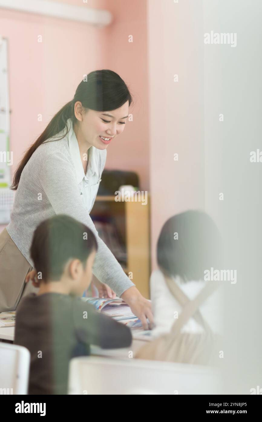 Teacher giving a lesson in the classroom Stock Photo - Alamy