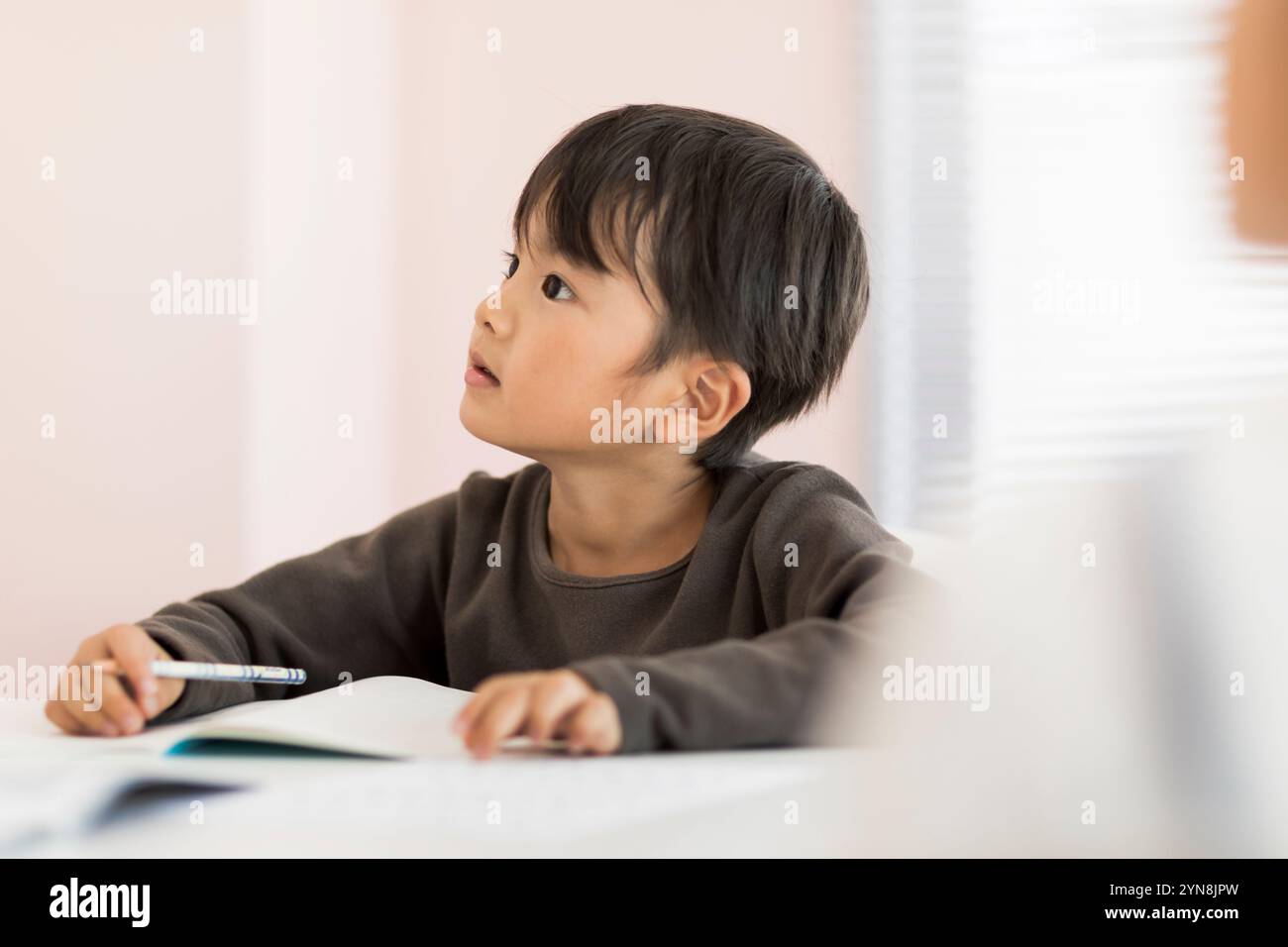 Boy taking a class in a classroom Stock Photo - Alamy
