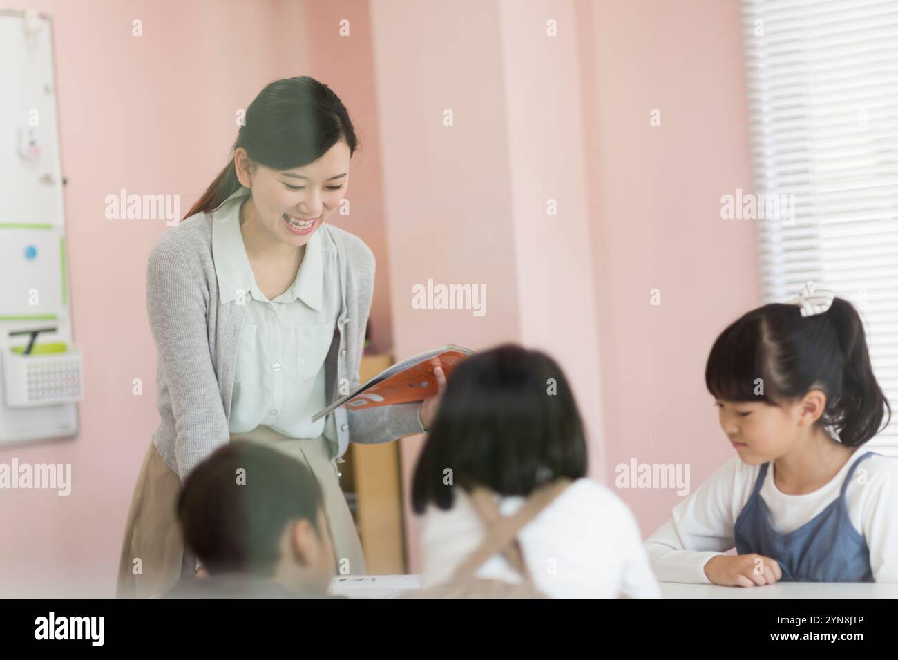 Teacher giving a lesson in the classroom Stock Photo - Alamy