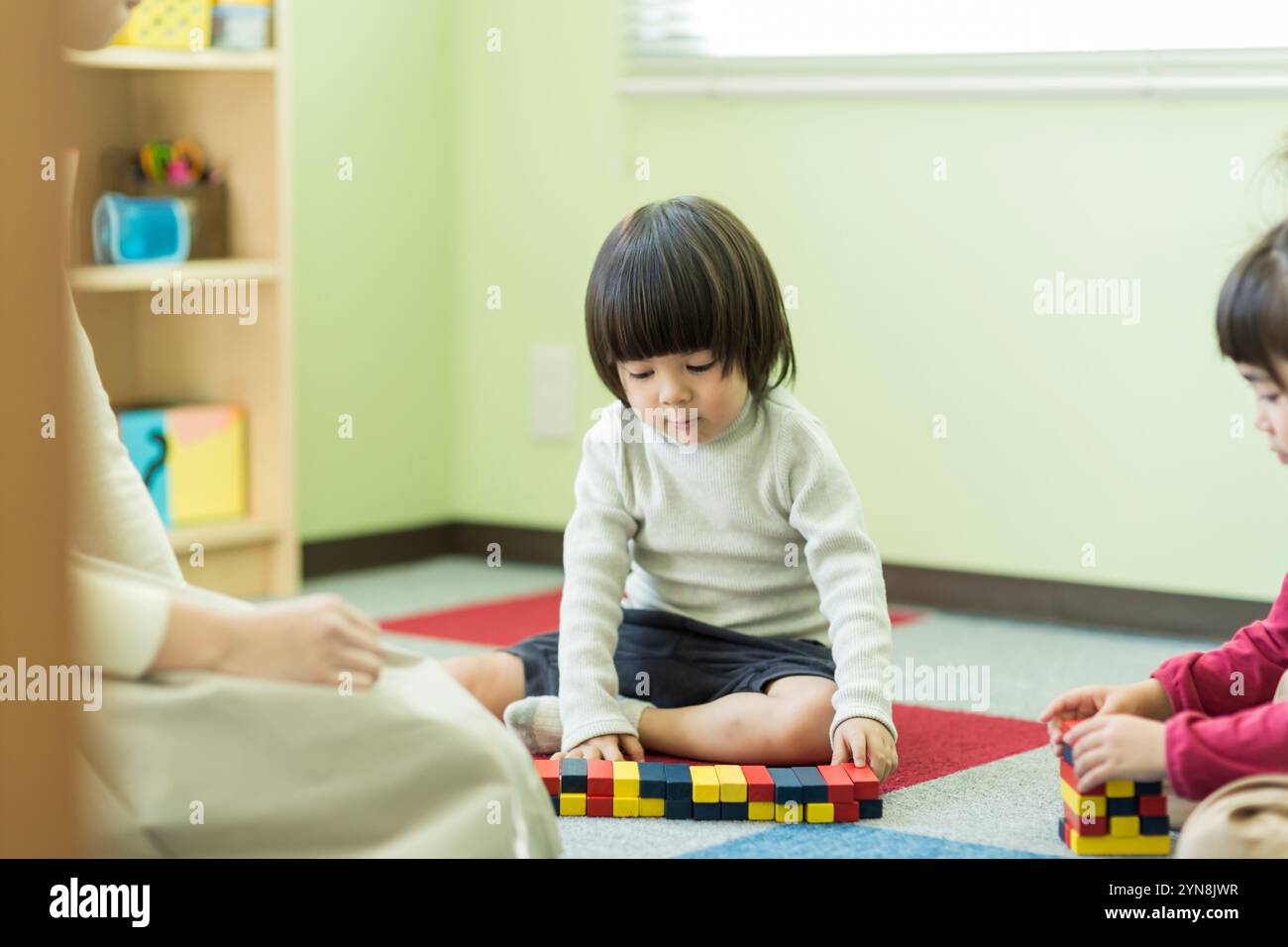 Boys learning in an early childhood classroom Stock Photo - Alamy