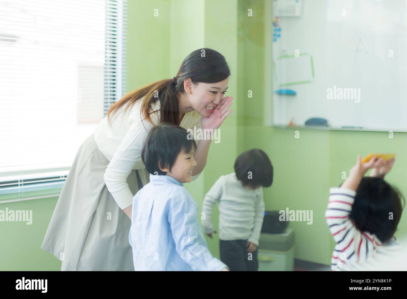 Teachers and children taking a class in a classroom Stock Photo - Alamy