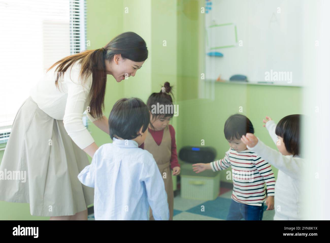 Teachers and children taking a class in a classroom Stock Photo - Alamy