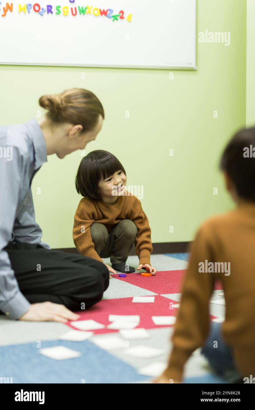Teachers and children giving an English lesson Stock Photo - Alamy
