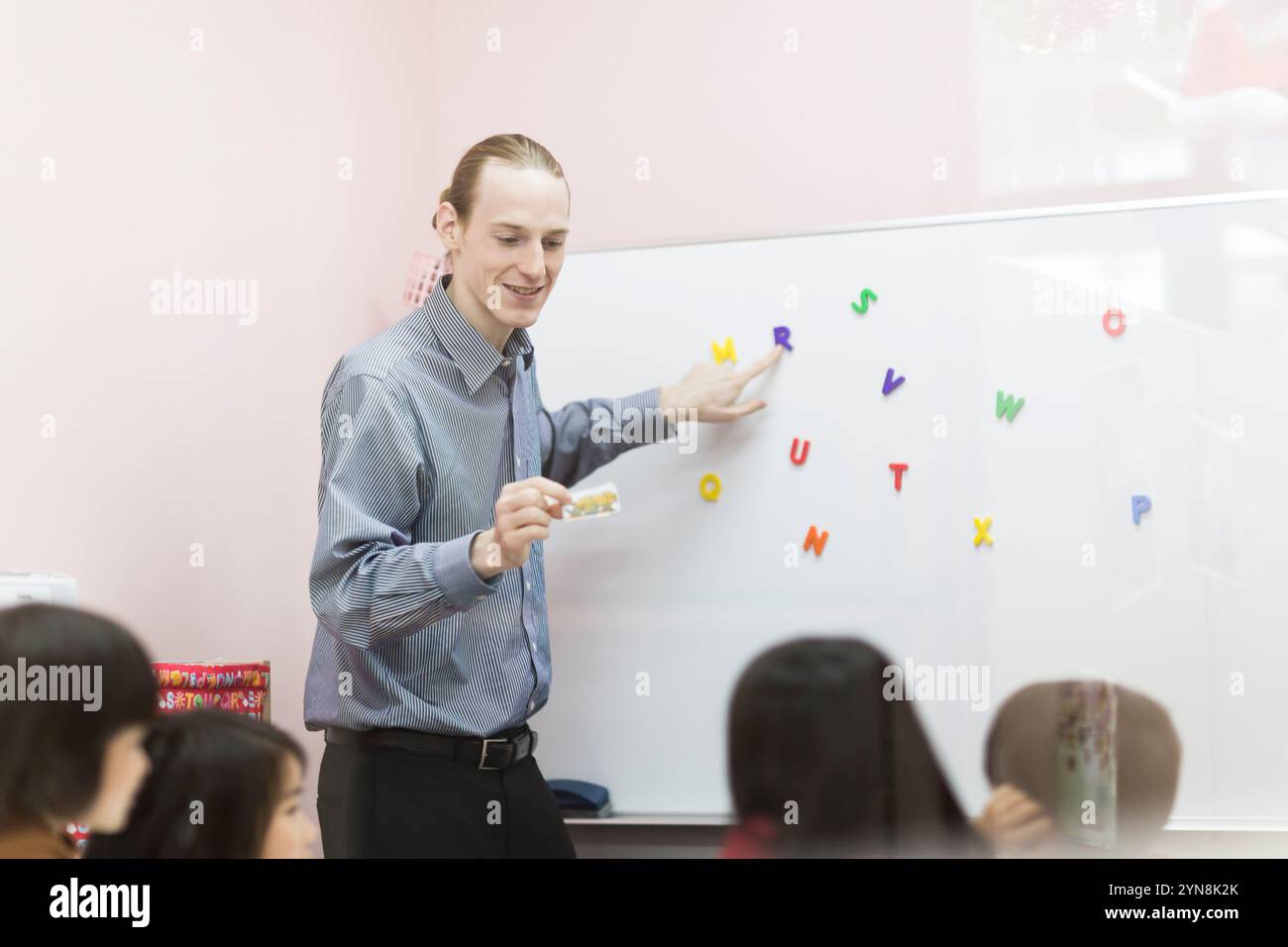Teachers and children giving an English lesson Stock Photo - Alamy