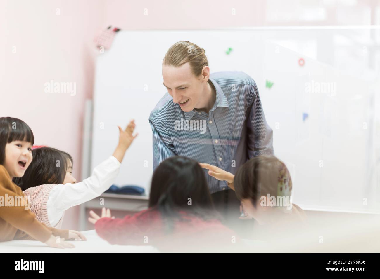 Teachers and children giving an English lesson Stock Photo - Alamy