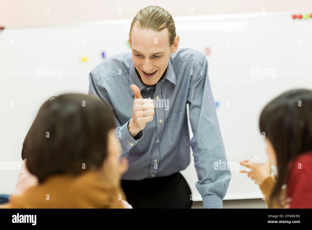 Teachers and children giving an English lesson Stock Photo - Alamy
