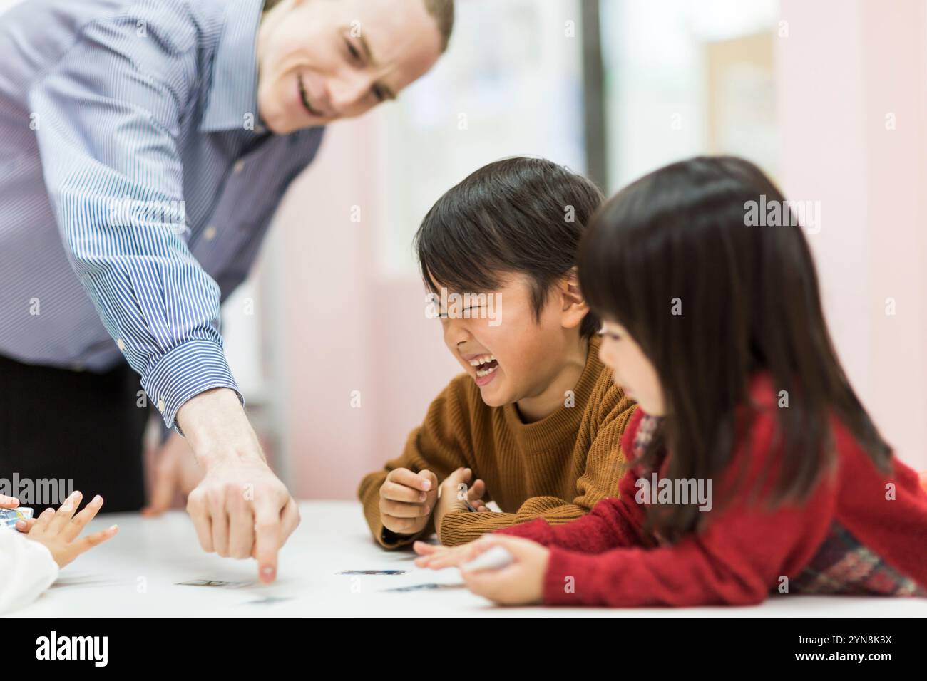 Teachers and children giving an English lesson Stock Photo - Alamy