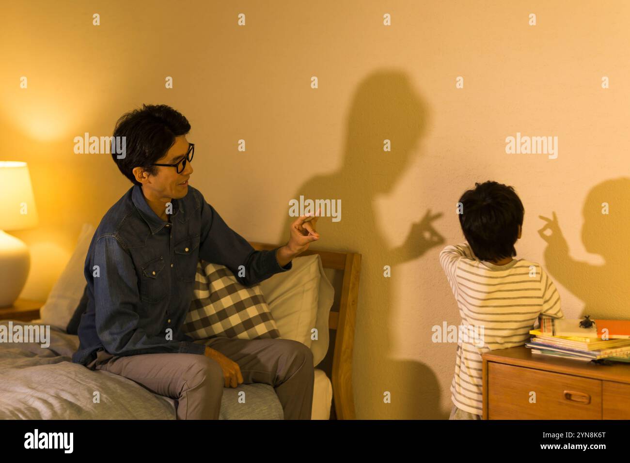 Father and son playing with shadow puppets Stock Photo - Alamy