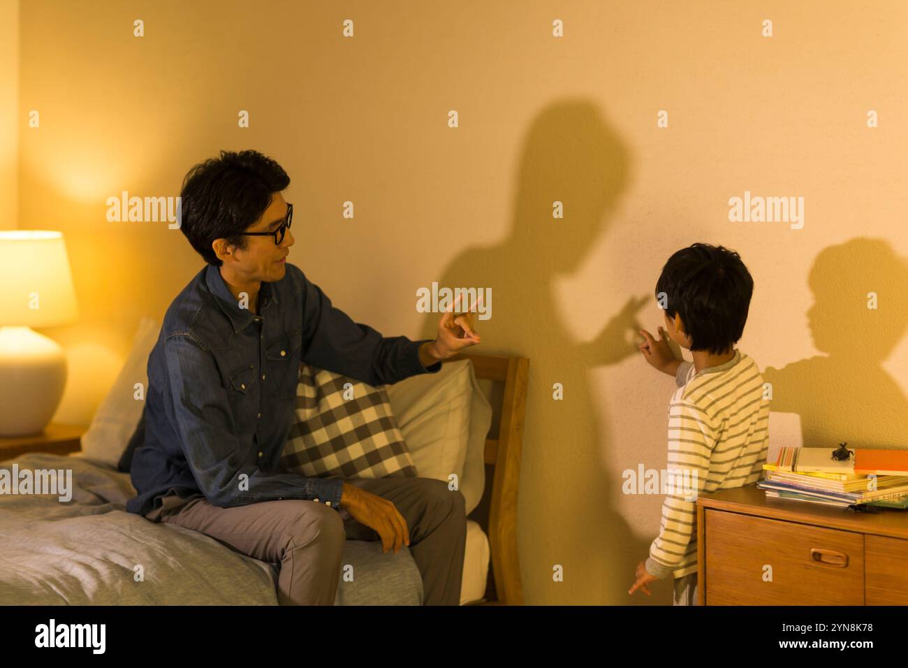 Father and son playing with shadow puppets Stock Photo - Alamy