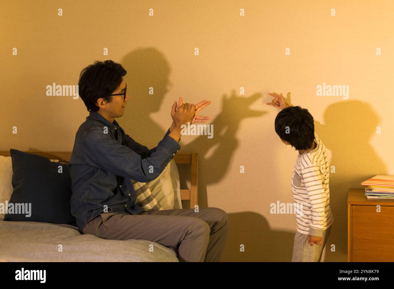 Father and son playing with shadow puppets Stock Photo - Alamy