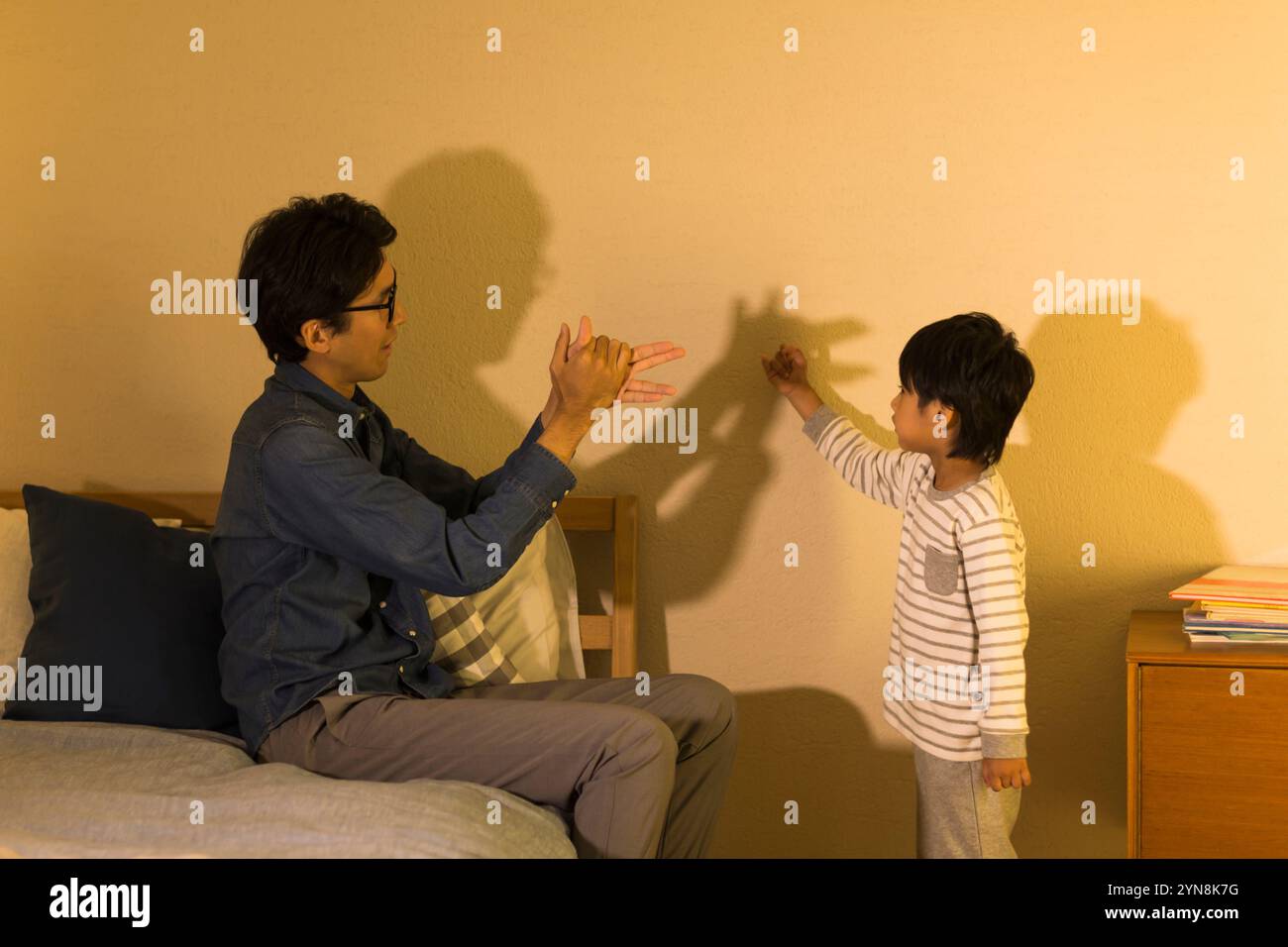 Father and son playing with shadow puppets Stock Photo - Alamy