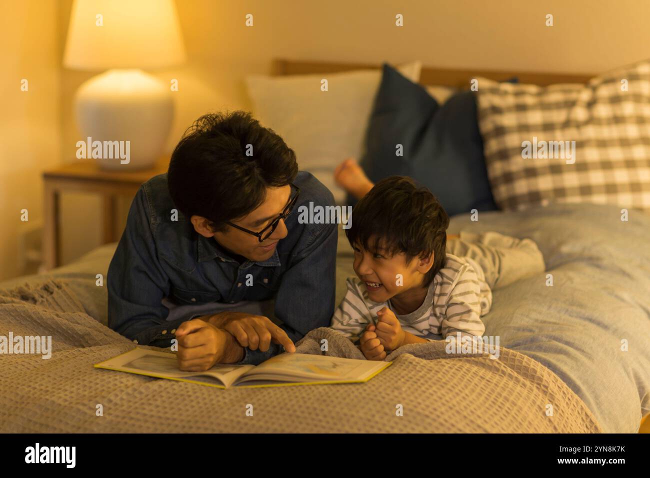 Boy reading book in bed hi-res stock photography and images - Alamy