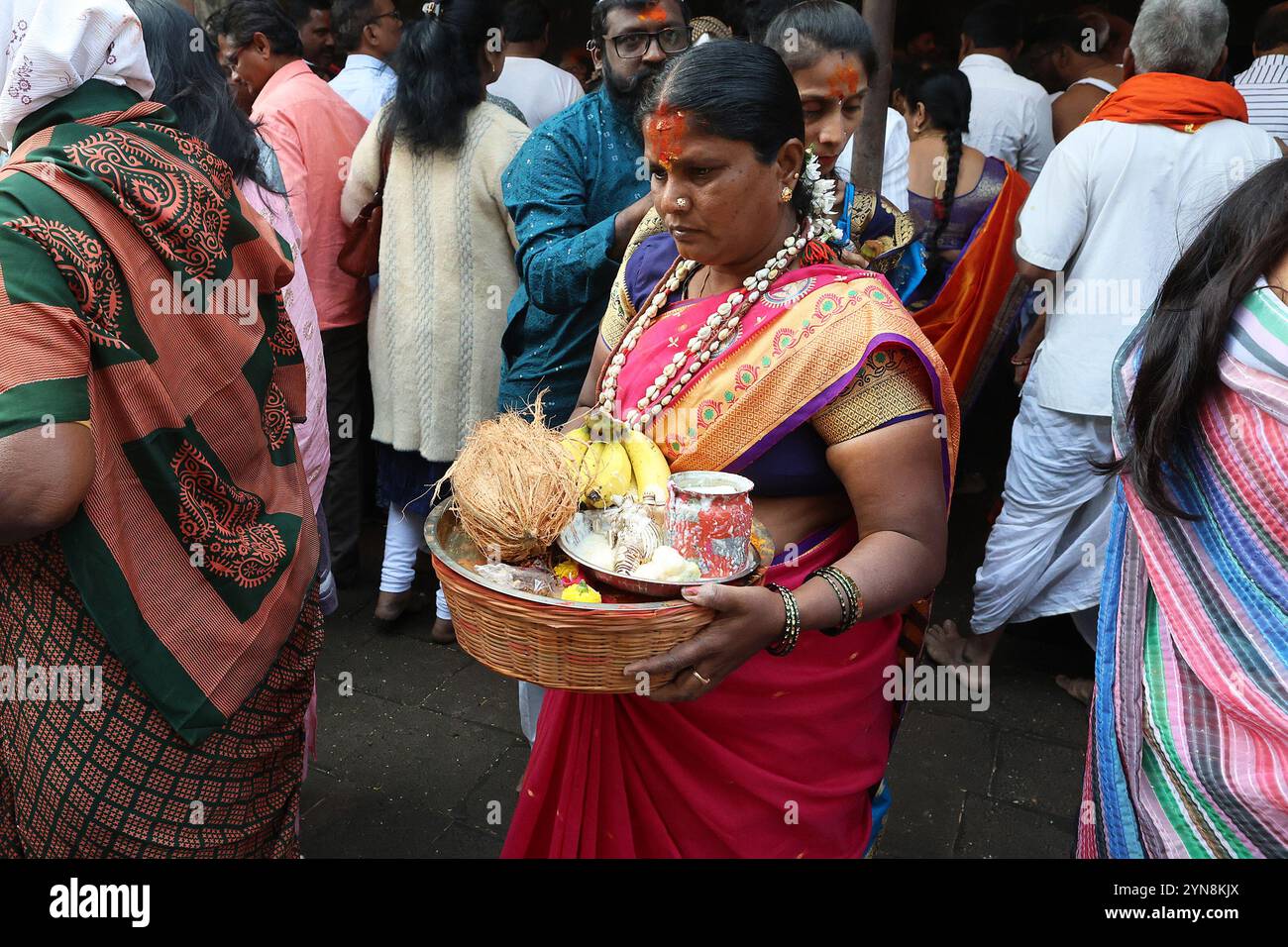 Pilgrim with a basket of holy offerings in the Sri Tuljabhavan Temple ...