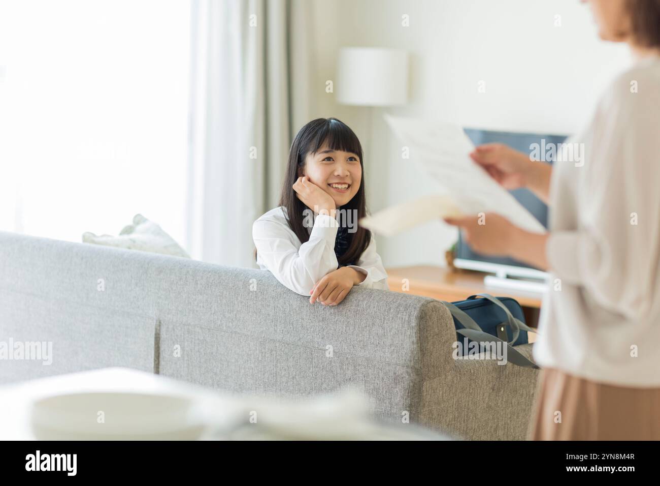 Girl showing her report card to her mother Stock Photo - Alamy