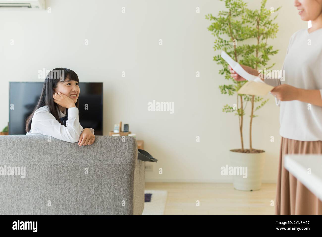 Girl showing her report card to her mother Stock Photo - Alamy