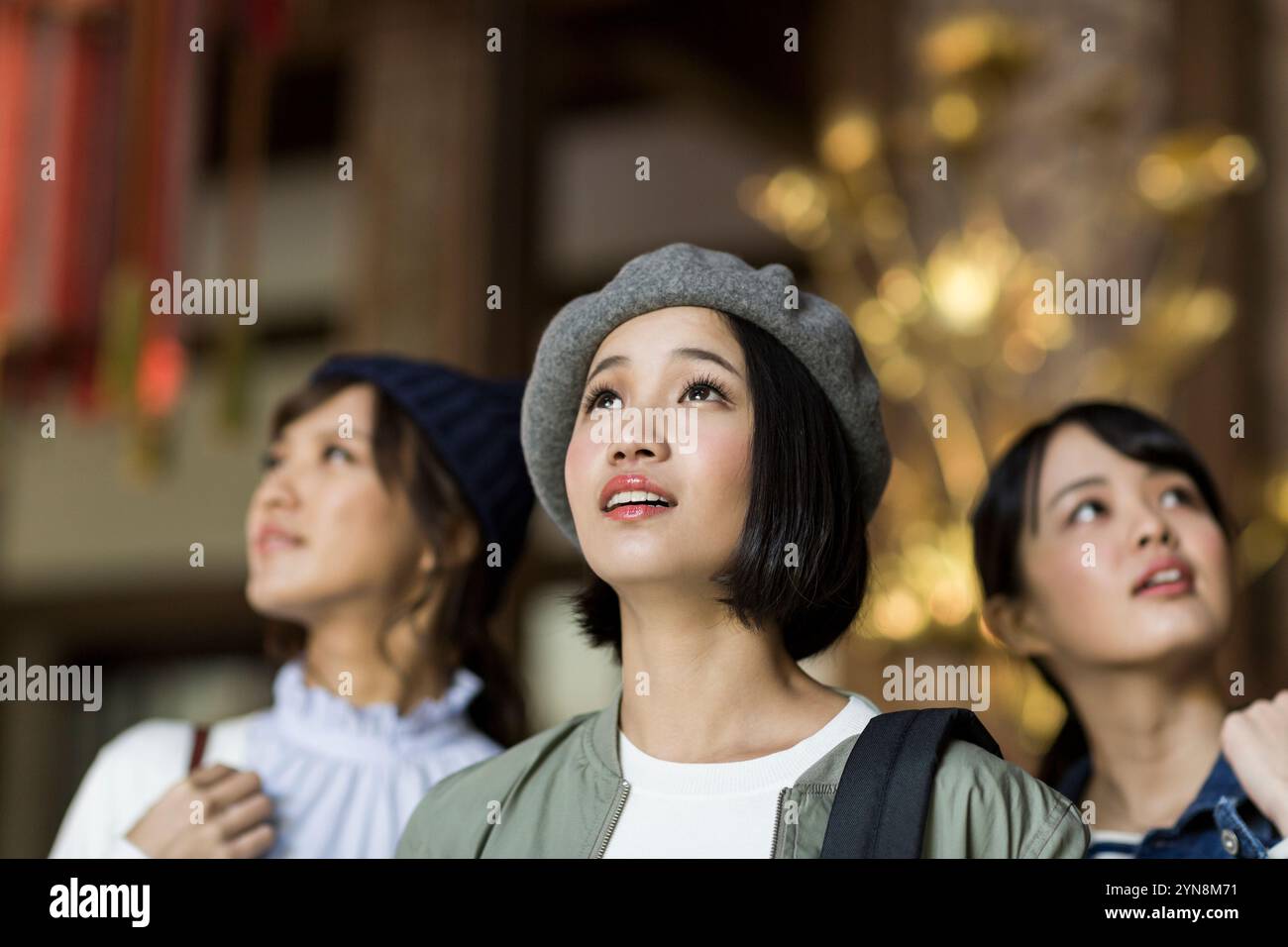 Three women touring the temple Stock Photo - Alamy