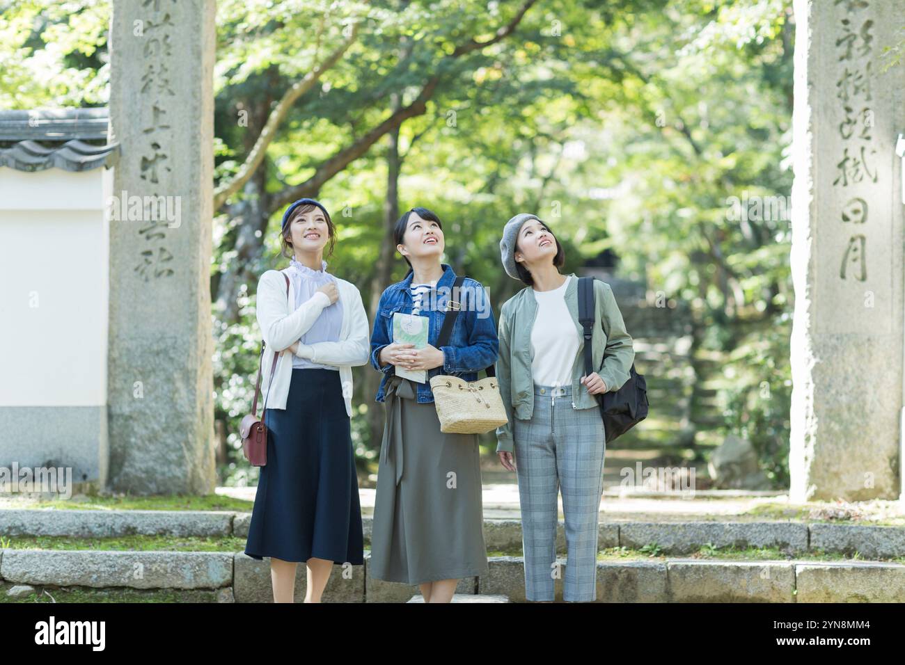 Three women touring the temple Stock Photo - Alamy