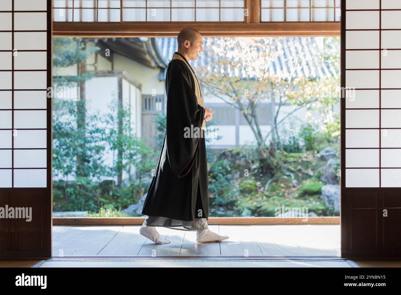 Resident priest walking along the veranda Stock Photo - Alamy
