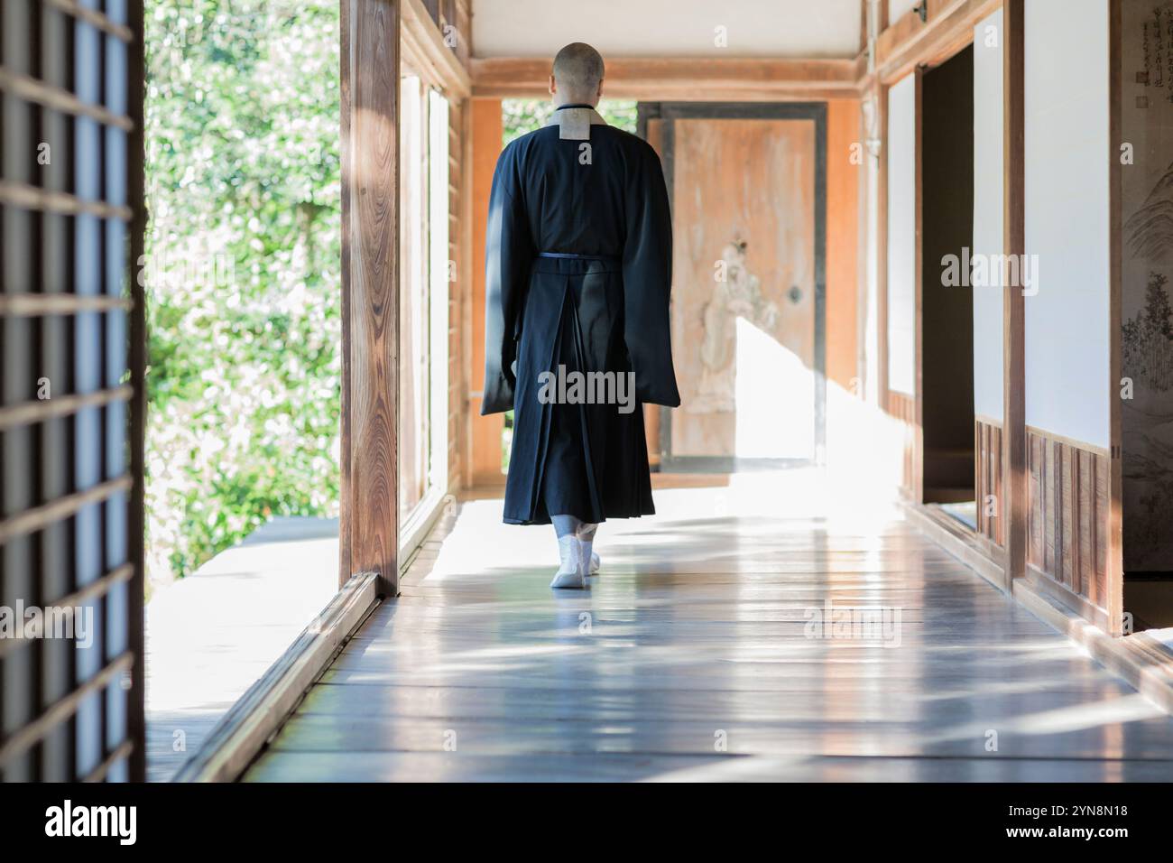 Resident priest walking along the veranda Stock Photo - Alamy
