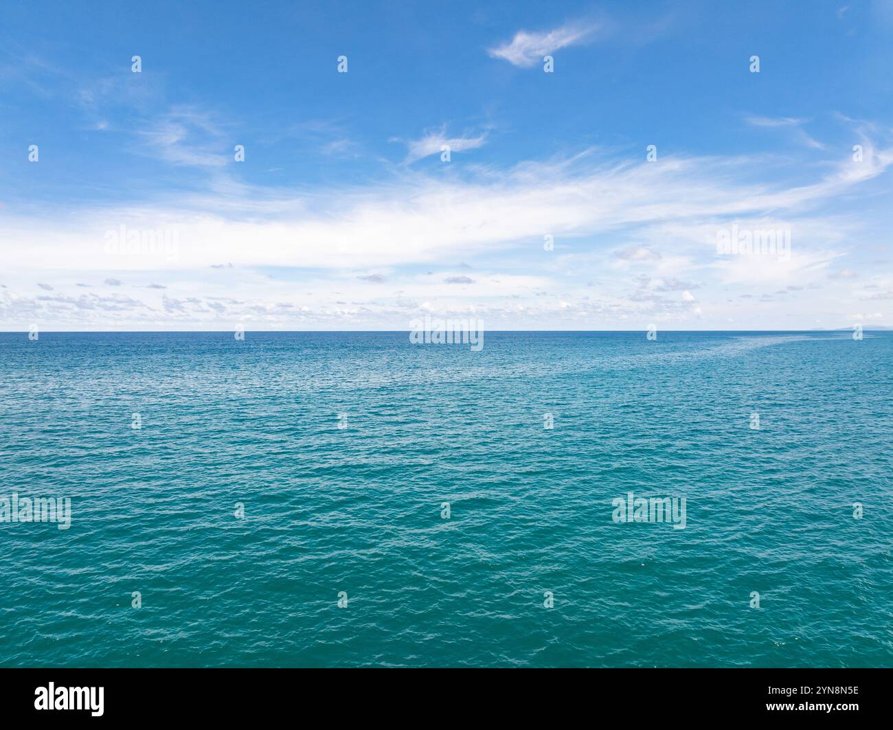 Aerial view of a blue sea surface water texture background and sun ...