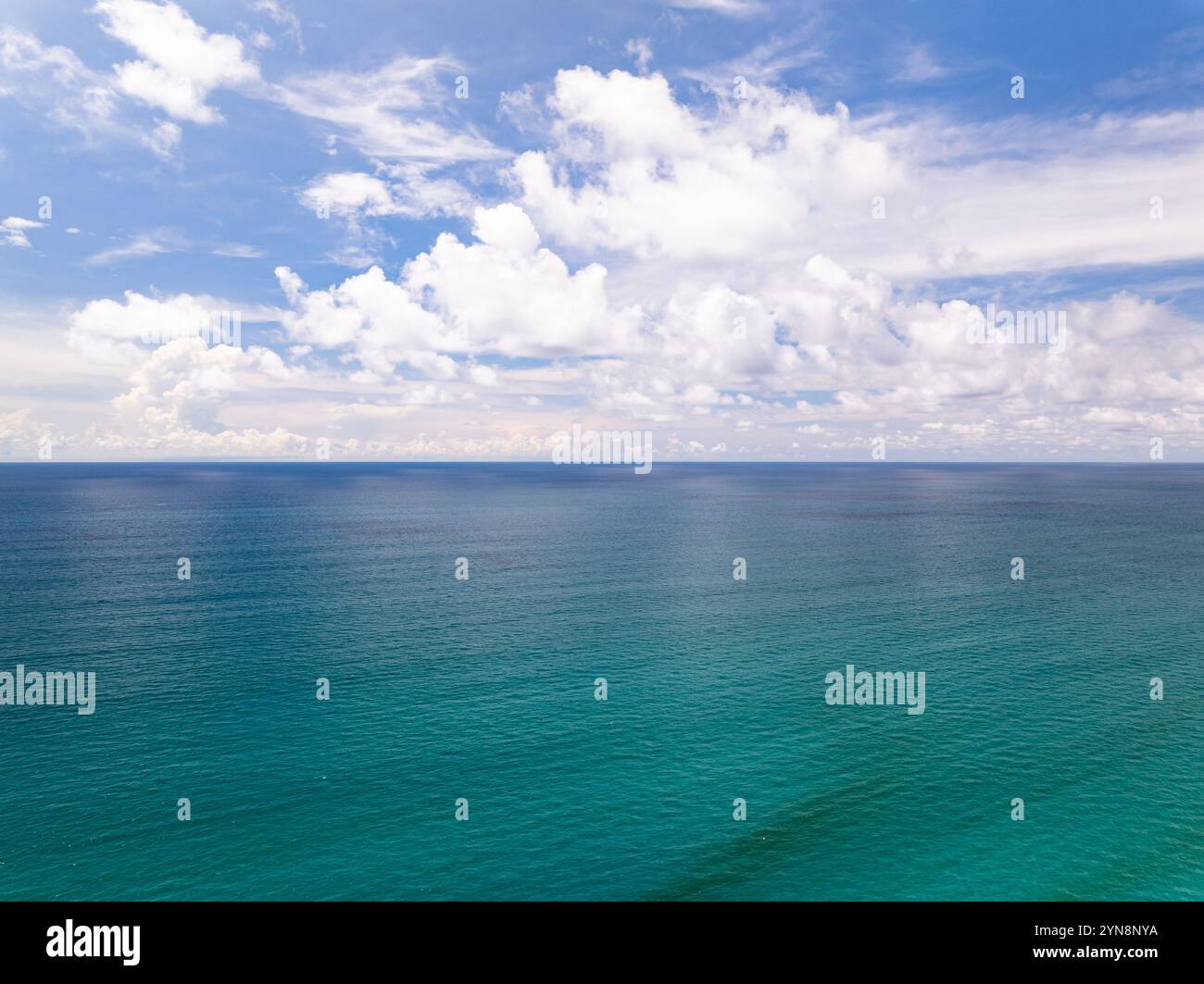 Aerial view of a blue sea surface water texture background and sun ...