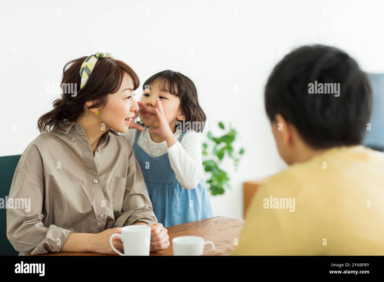 A girl talking privately to her mother Stock Photo - Alamy