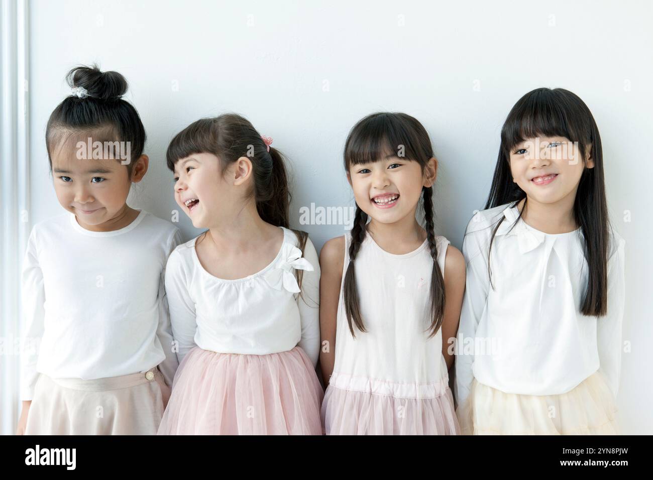 Four girls smiling Stock Photo - Alamy