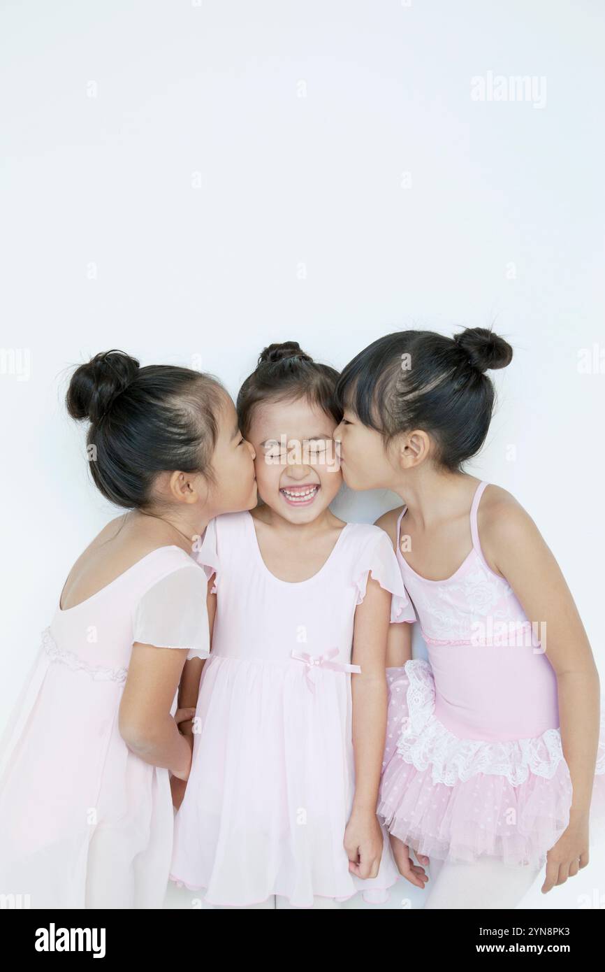 Three girls kissing Stock Photo - Alamy